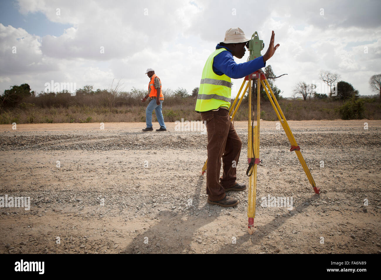 A surveyor works along the Namialo to Rio Lurio Road in Northern ...
