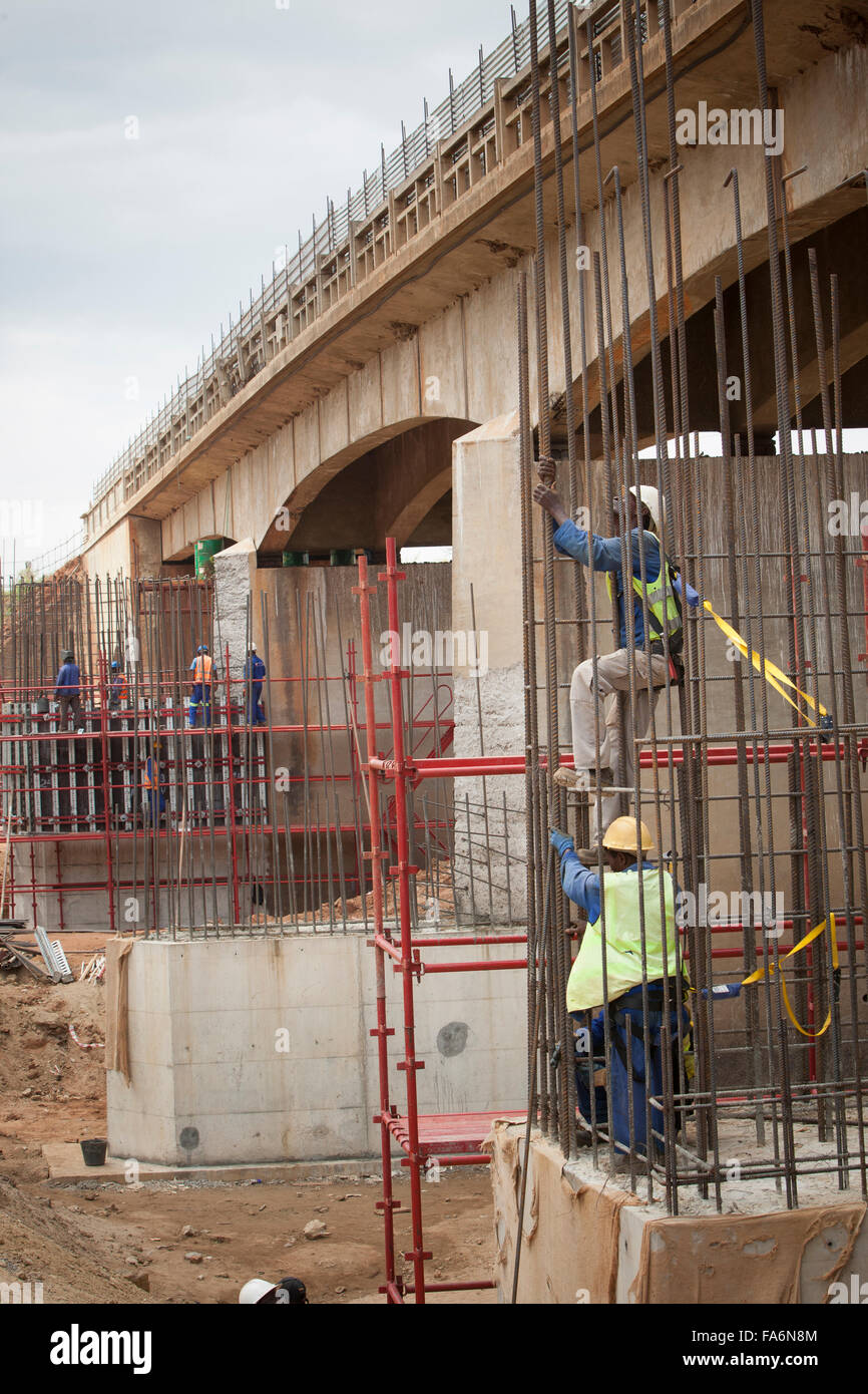 Construction workers rehabilitate an aging bridge along the Namialo to ...
