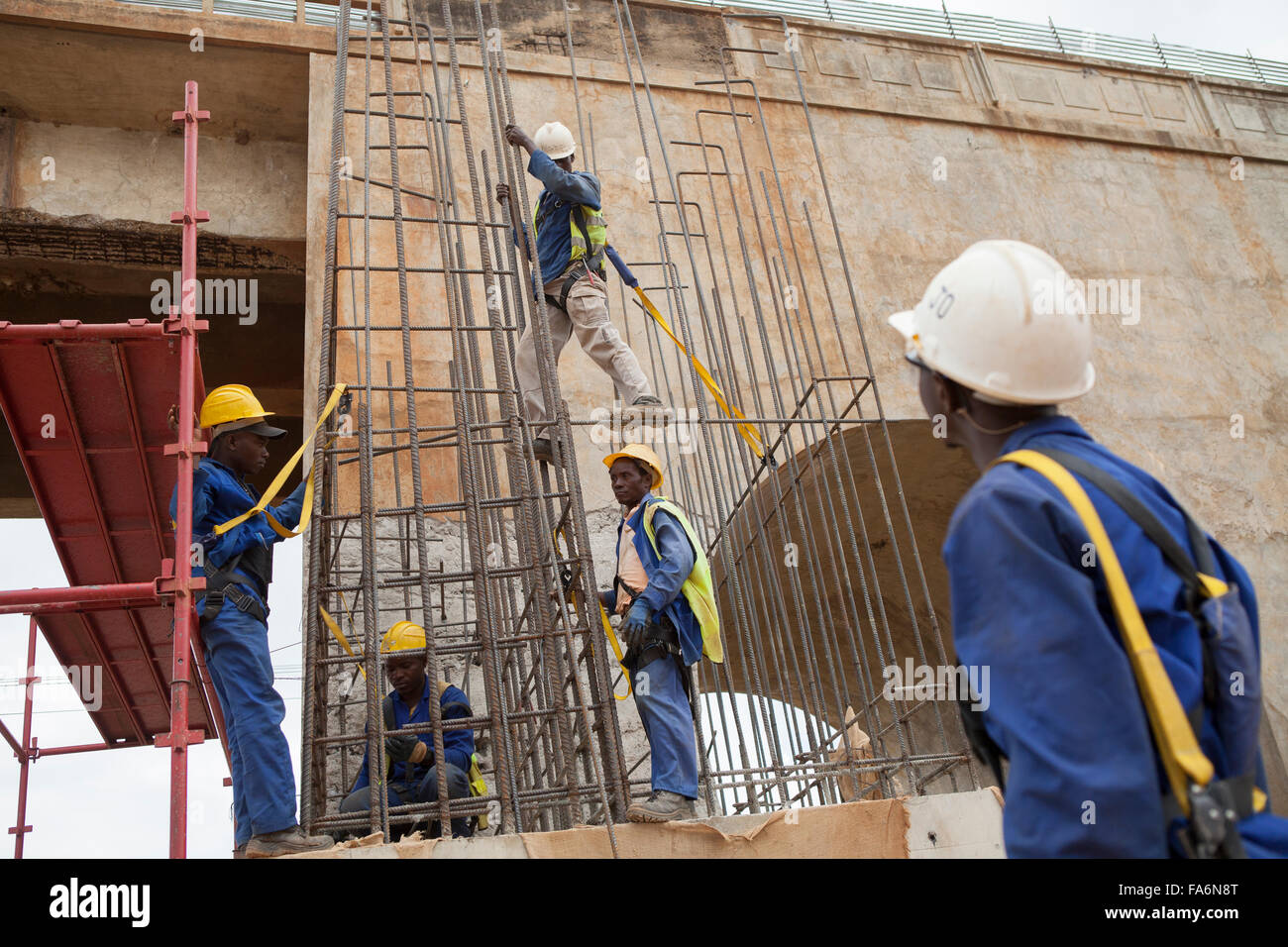 Construction workers rehabilitate an aging bridge along the Namialo to ...