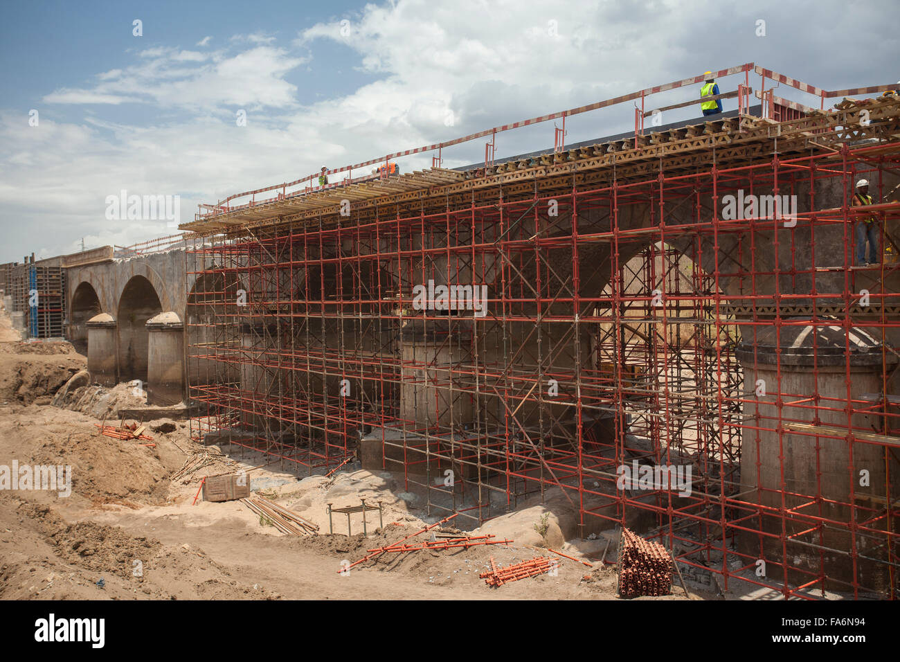 Construction workers rehabilitate an aging bridge along the Namialo to ...