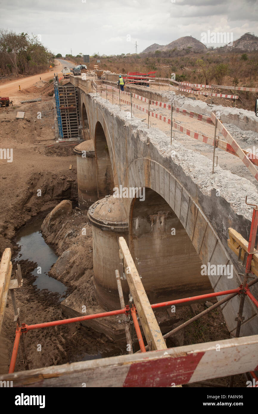 Construction workers rehabilitate an aging bridge along the Namialo to ...