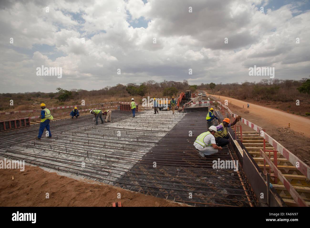 Construction workers rehabilitate an aging bridge along the Namialo to ...