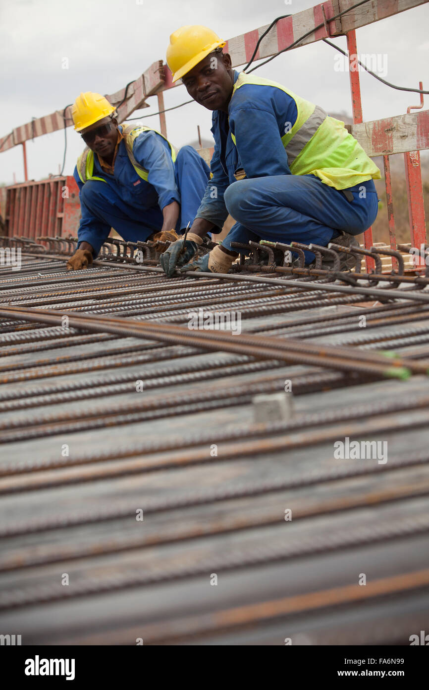 Construction workers rehabilitate an aging bridge along the Namialo to ...