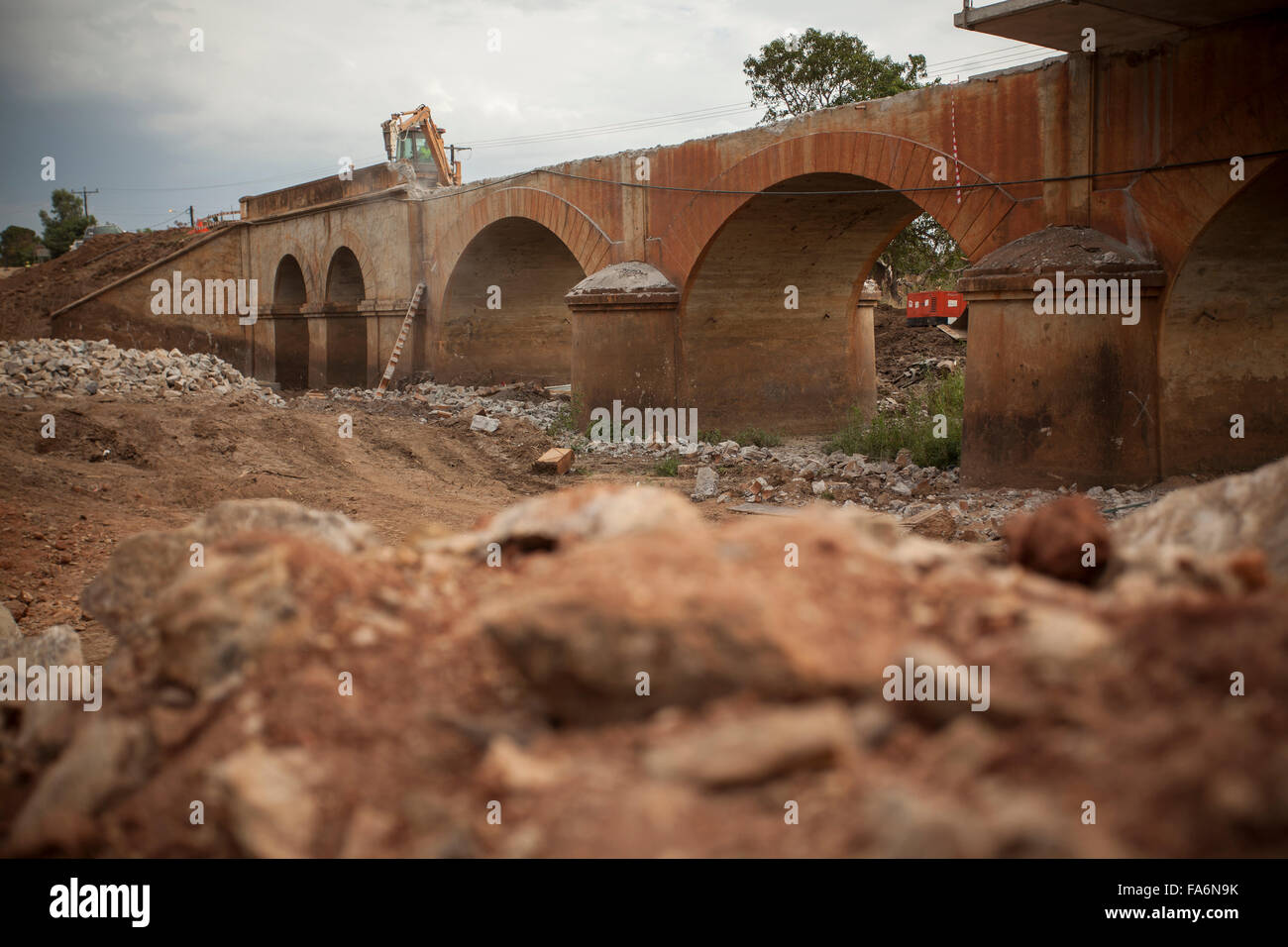 Construction workers rehabilitate an aging bridge along the Namialo to ...