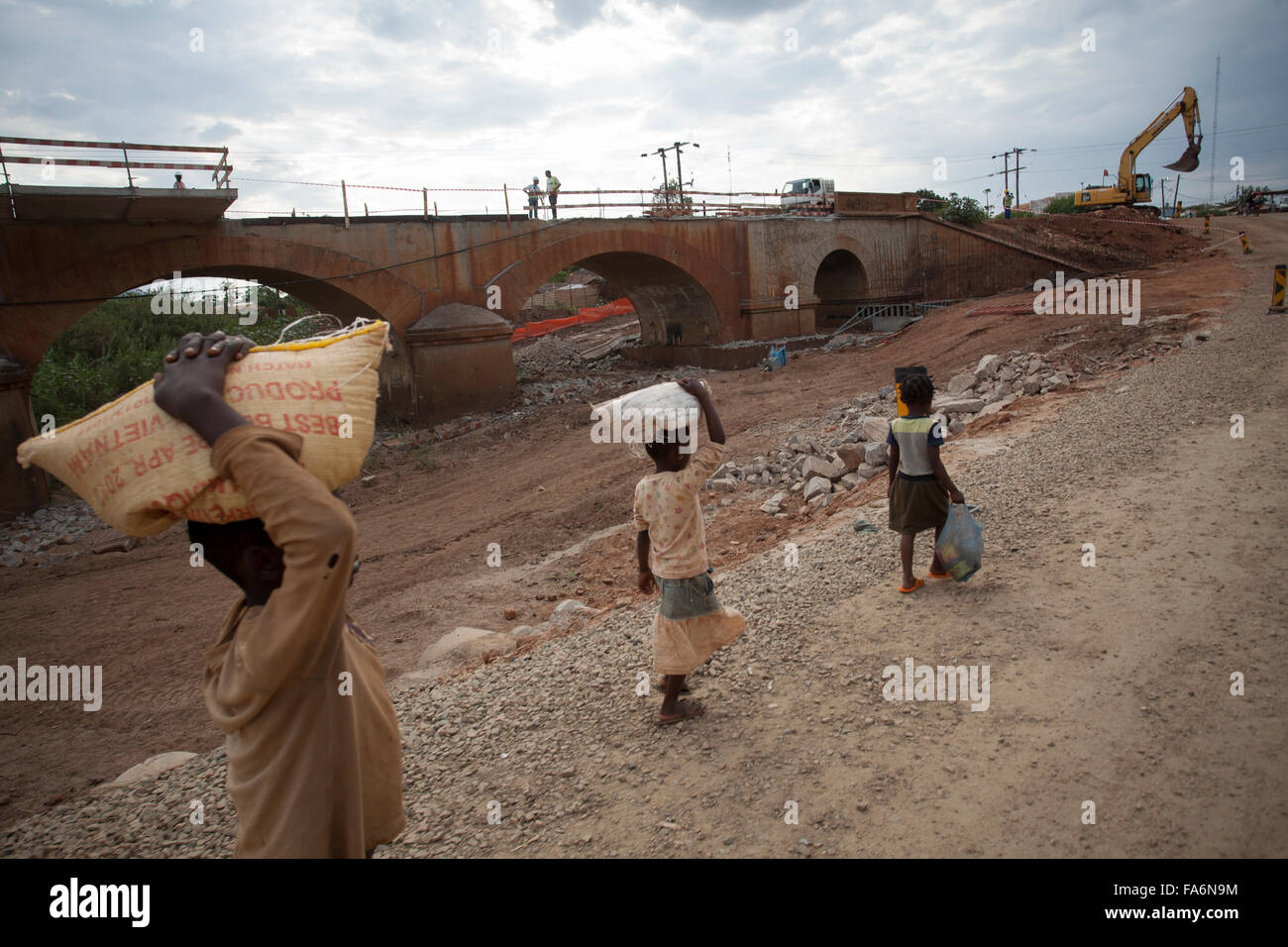 Construction workers rehabilitate an aging bridge along the Namialo to ...