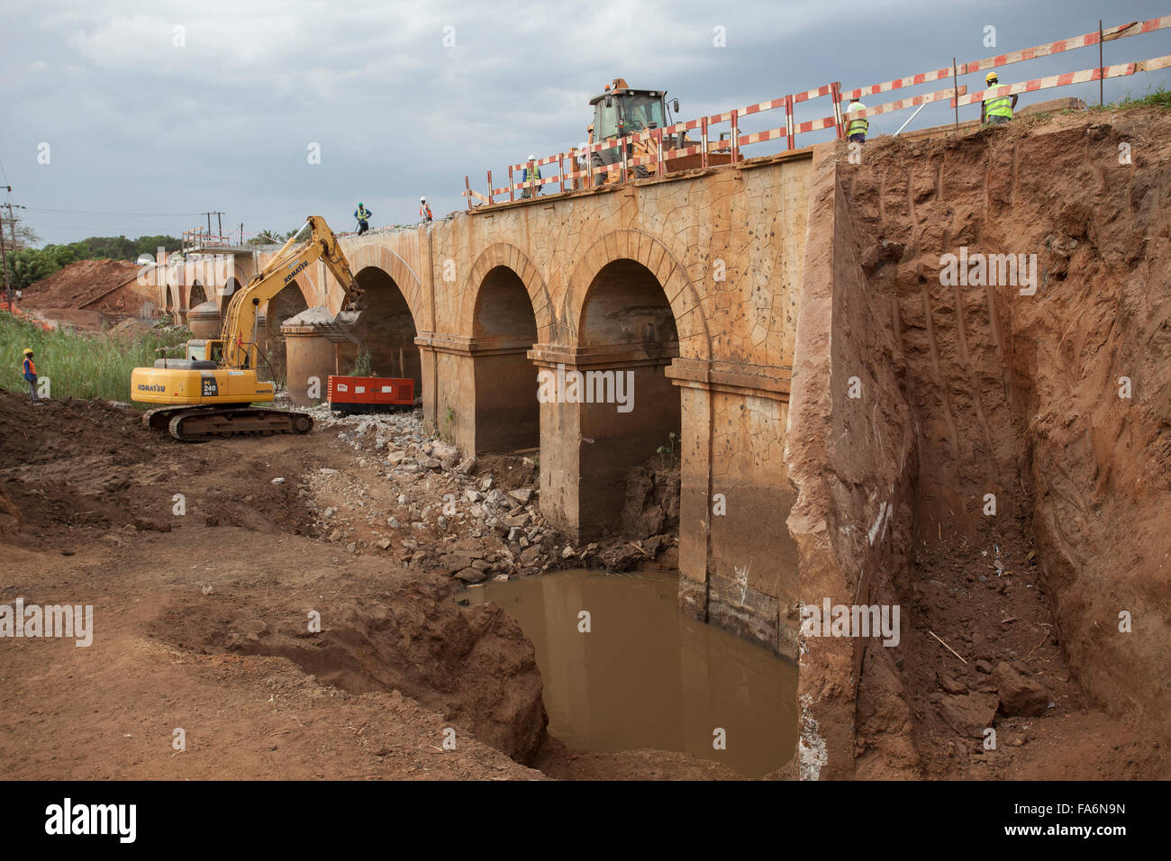 Construction workers rehabilitate an aging bridge along the Namialo to ...