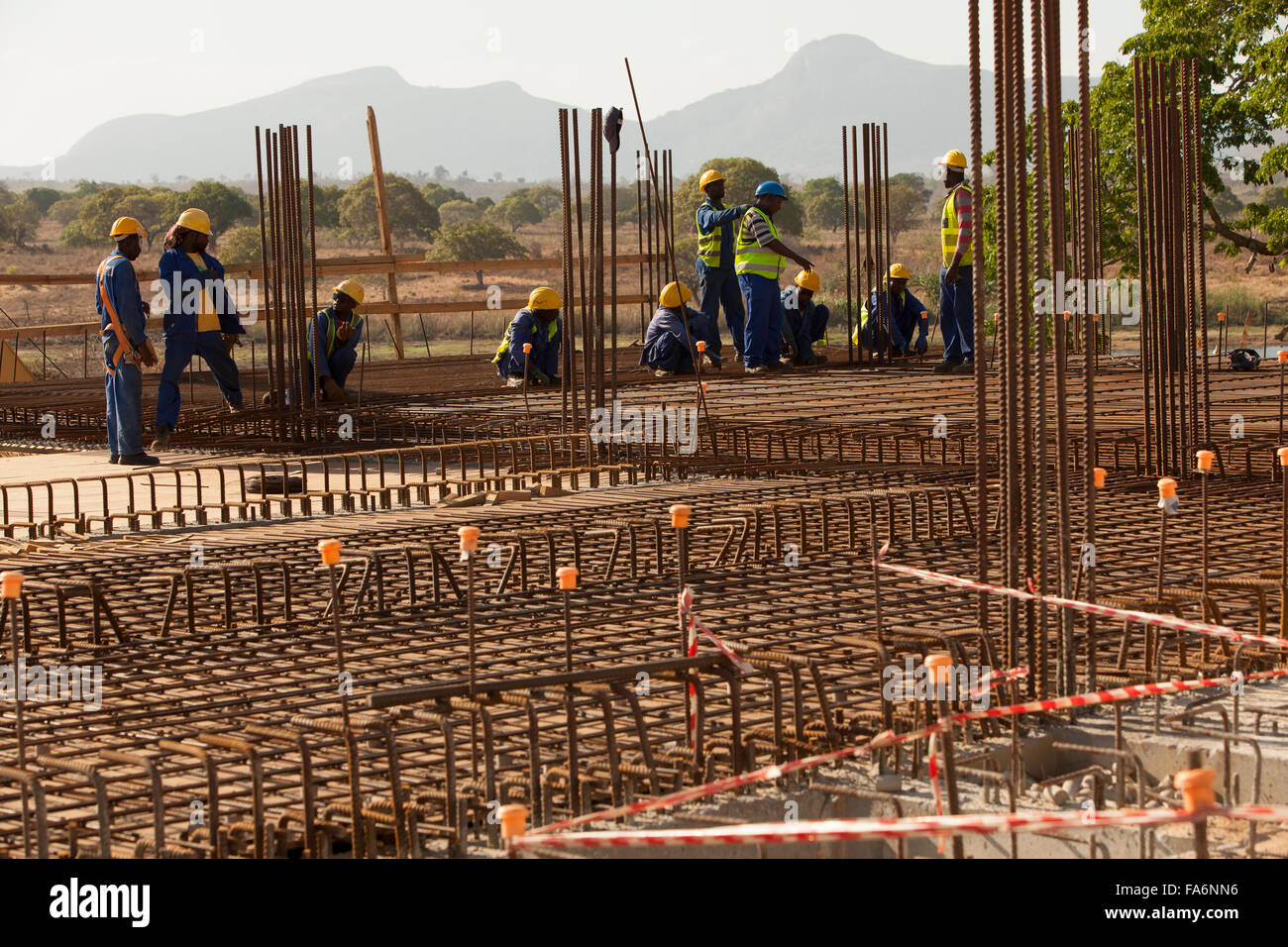 Workers construct a new pumping station near the Manapo Dam in Nampula ...