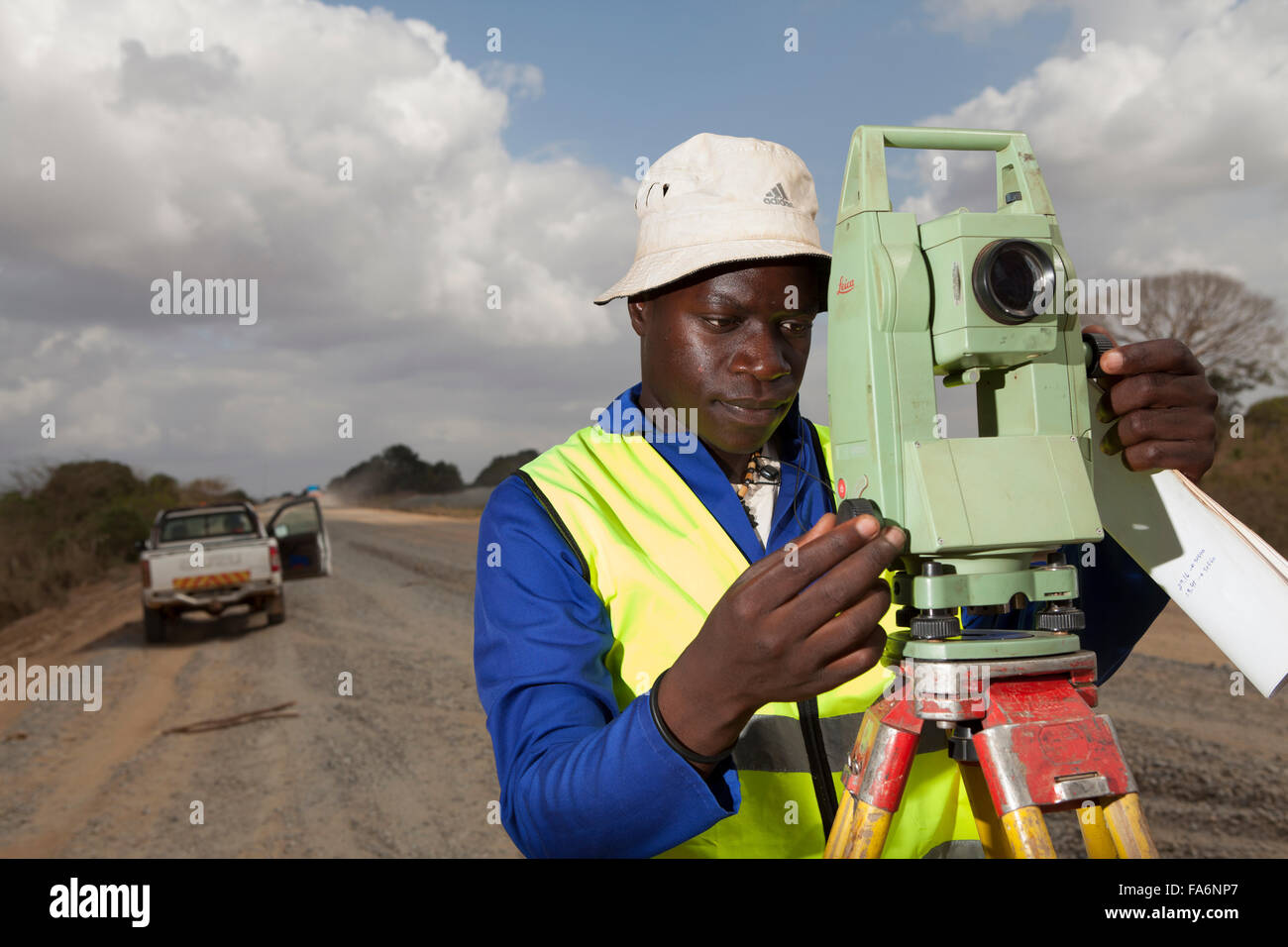 A surveyor works along the Namialo to Rio Lurio Road in Northern ...