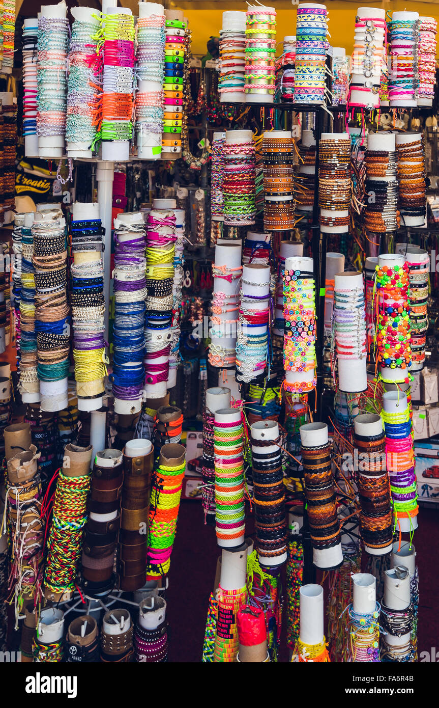 Many Different Colorful Bracelets in the Souvenir Shop on Paper Rolls ...