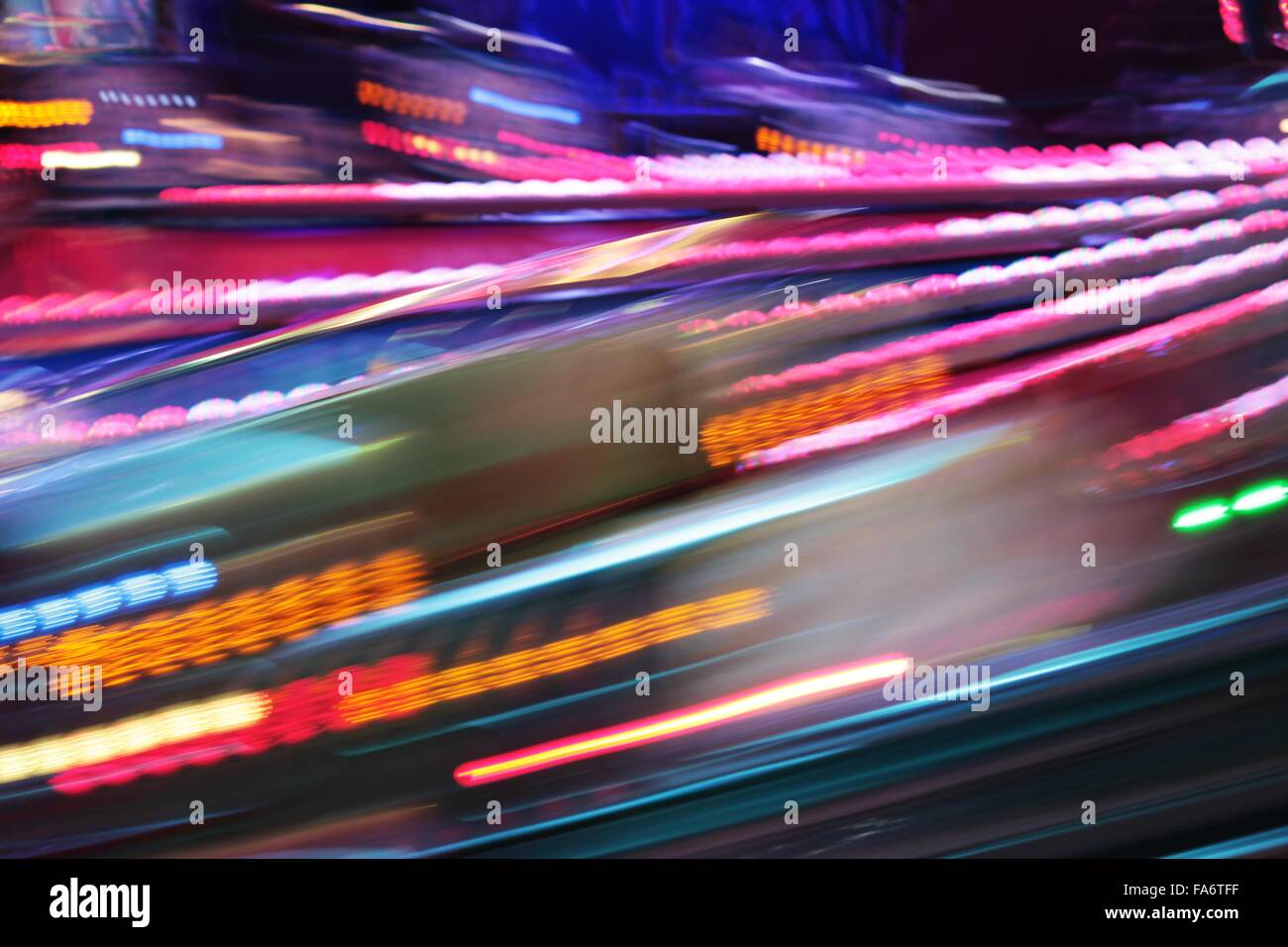 fairground funfair ride moving fast fair lights Night colours of the ...