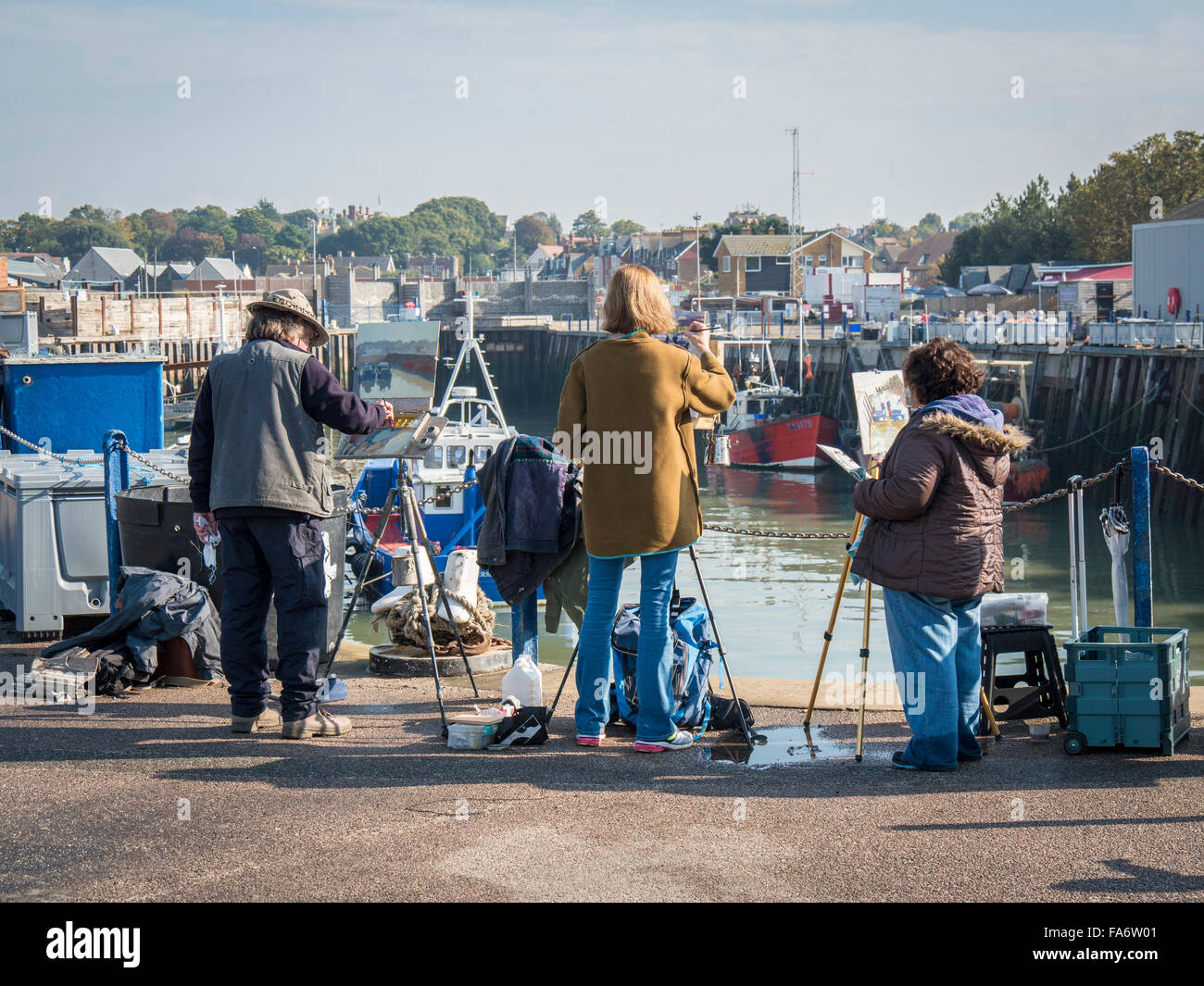 Group of artists painting at Whitstable harbour, Whitstable, Kent, UK ...
