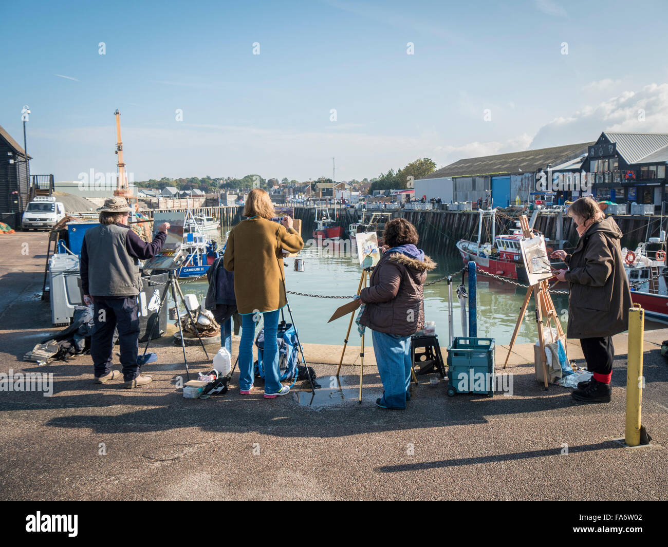 Group of artists painting at Whitstable harbour, Whitstable, Kent, UK ...