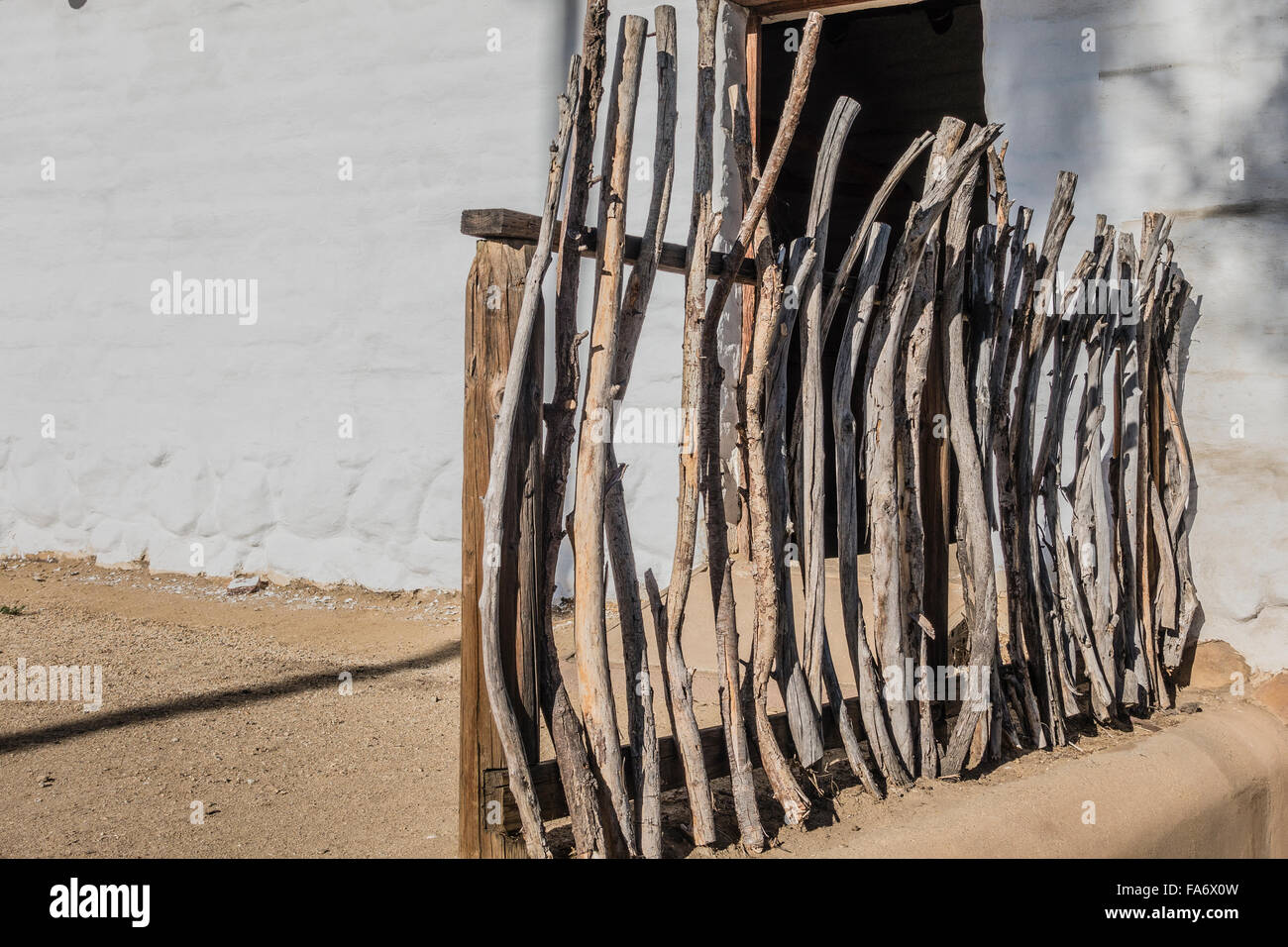 A close-up view of a primitive style fence made out of tree branches at ...