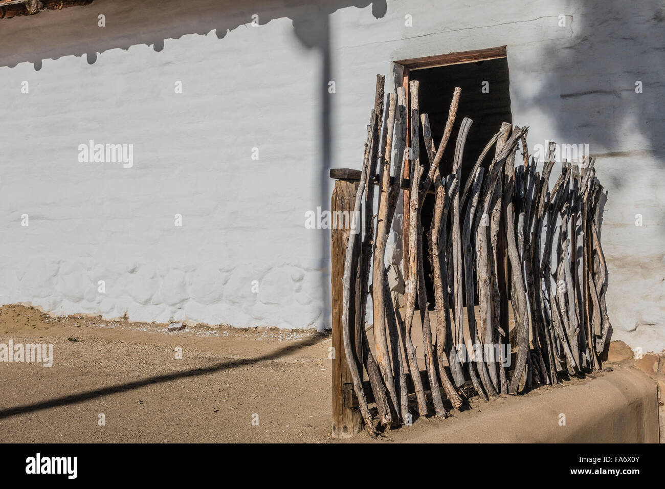 A close-up view of a primitive style fence made out of tree branches at ...