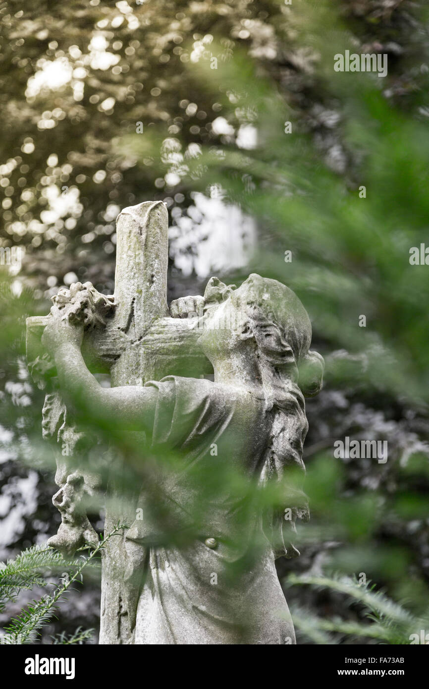 Close up of sculpture hidden behind tree hi-res stock photography and ...