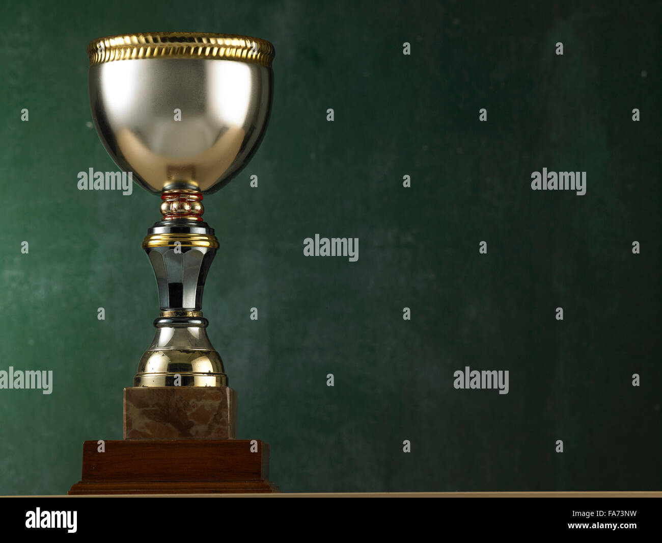 big trophy in front of the black board Stock Photo - Alamy