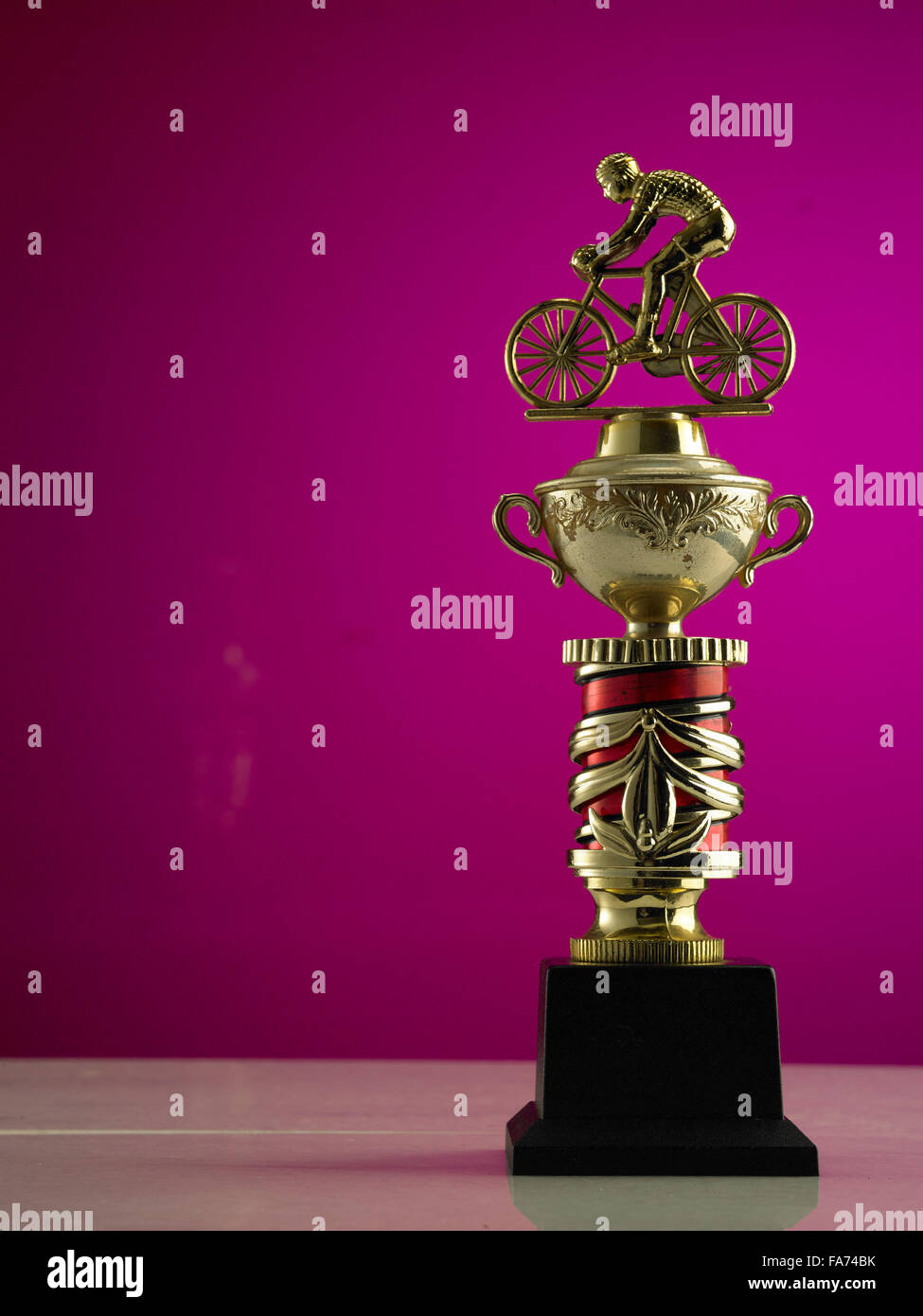 Trophy against the pink glass background Stock Photo - Alamy