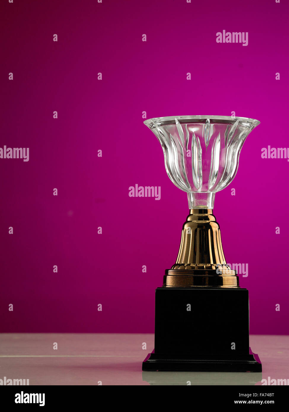 Trophy against the pink glass background Stock Photo - Alamy