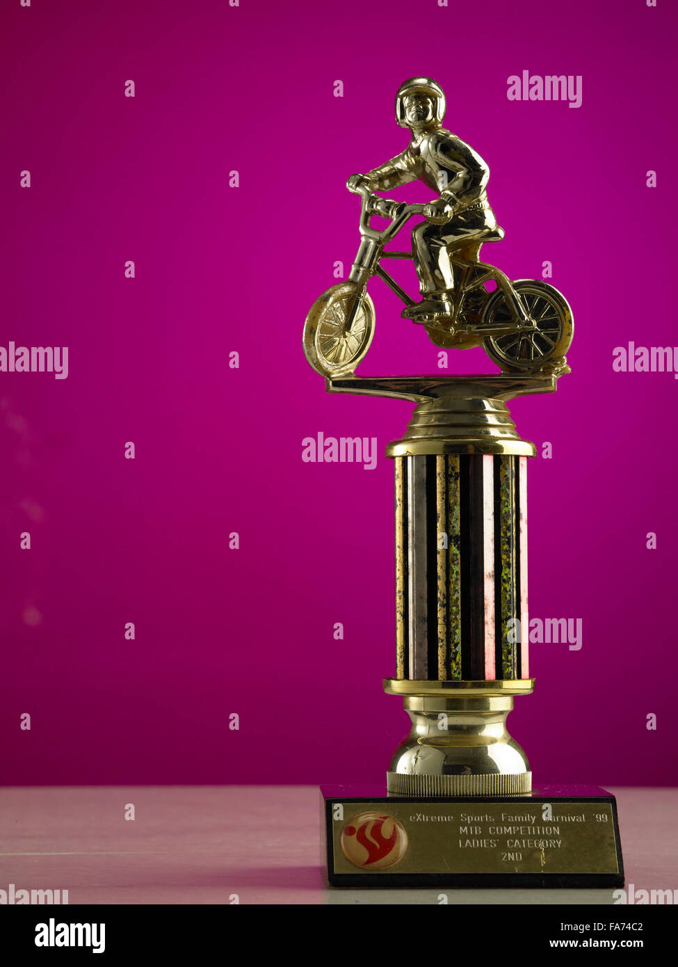 Trophy against the pink glass background Stock Photo - Alamy
