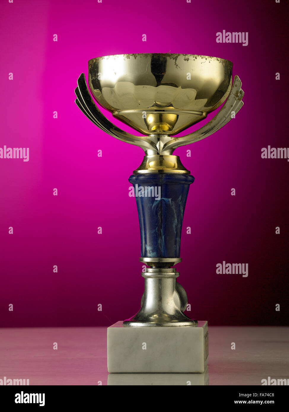 Trophy against the pink glass background Stock Photo - Alamy