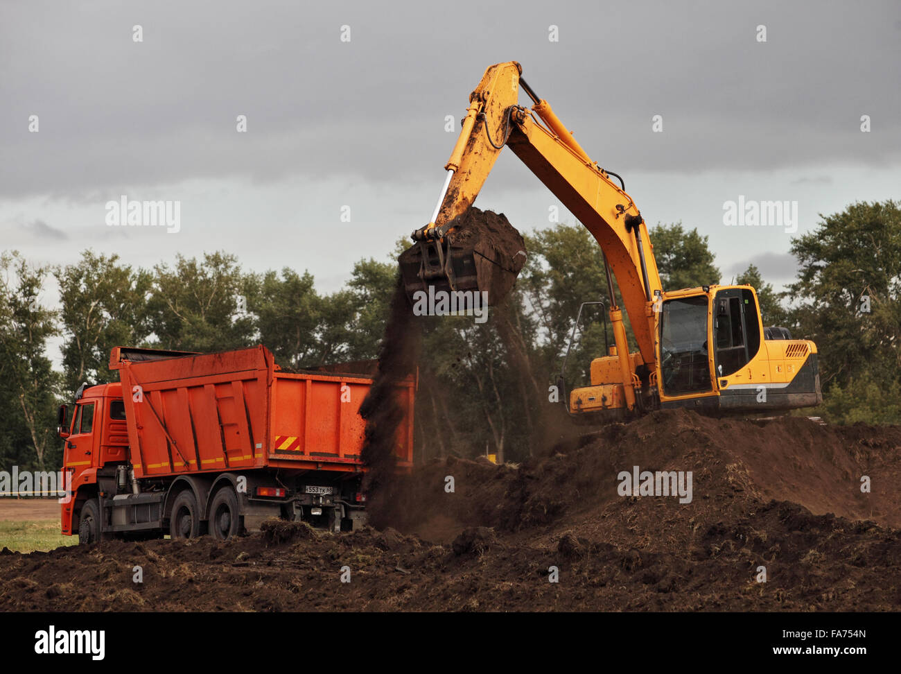 Excavating at road construction site Stock Photo - Alamy