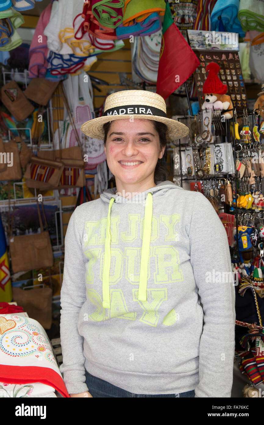Stallholder poses with a straw hat in the public market in Funchal ...