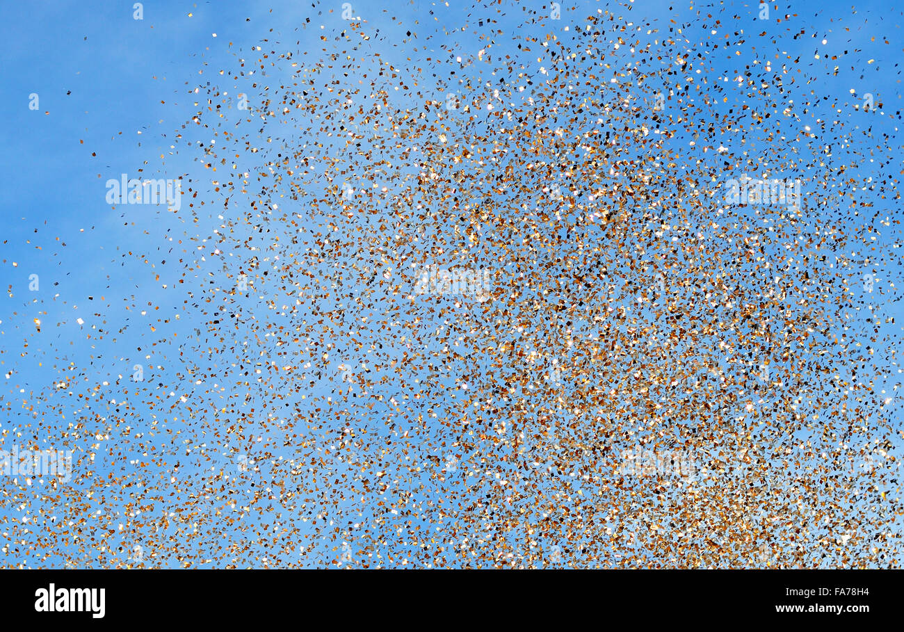 golden rain of the golden confetti in the city festival Stock Photo - Alamy