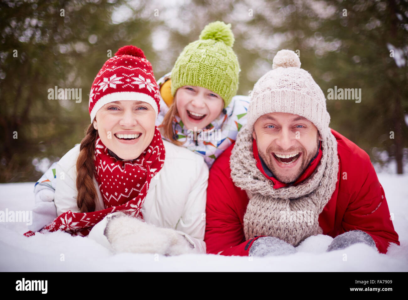 Happy family in warm clothing in winter outdoors Stock Photo - Alamy