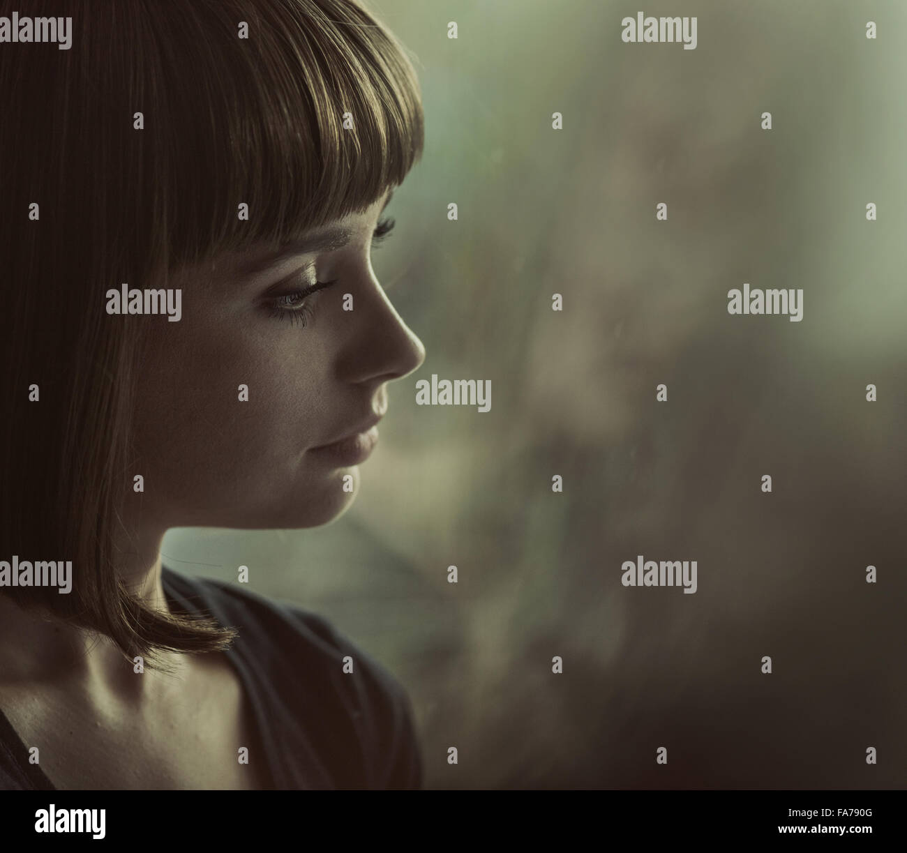 Portrait of a nostalgic brunette woman Stock Photo - Alamy