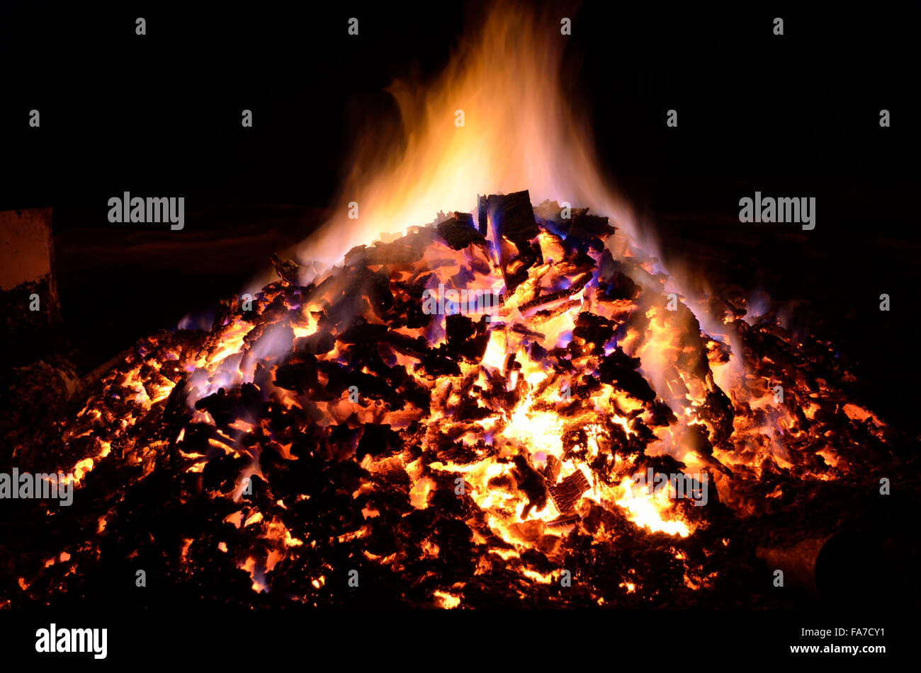 beautiful red hot glowing ember pile with colorful flames in winter ...