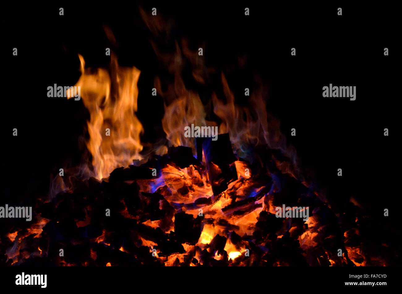 beautiful red hot glowing ember pile with colorful flames in winter ...