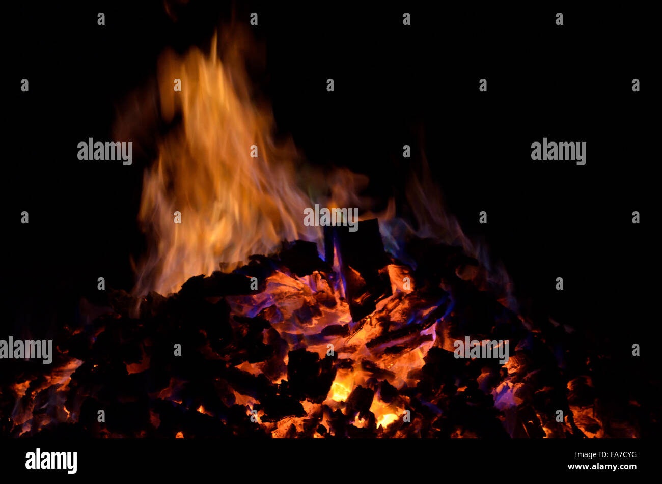 beautiful red hot glowing ember pile with colorful flames in winter ...