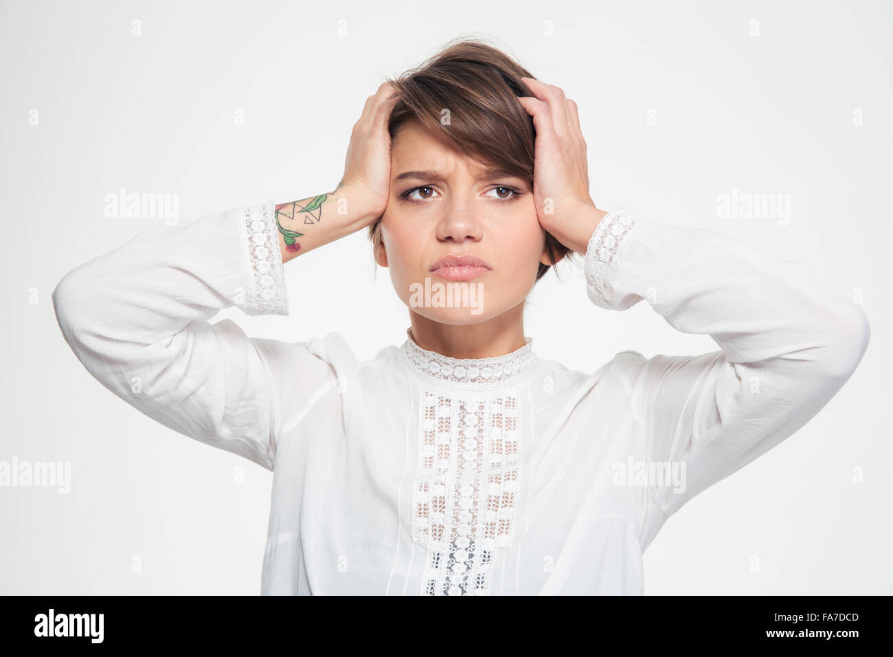 Depressed sad young female with short haircut holding head with hands ...
