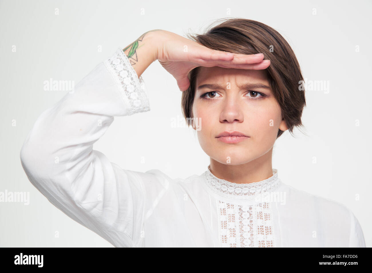 Concentrated beautiful young woman with short haircut holding hand near ...