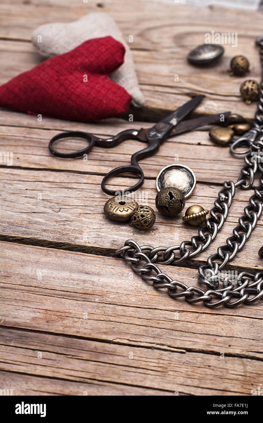 Retro scissors,beads for handicraft and iron chain Stock Photo - Alamy