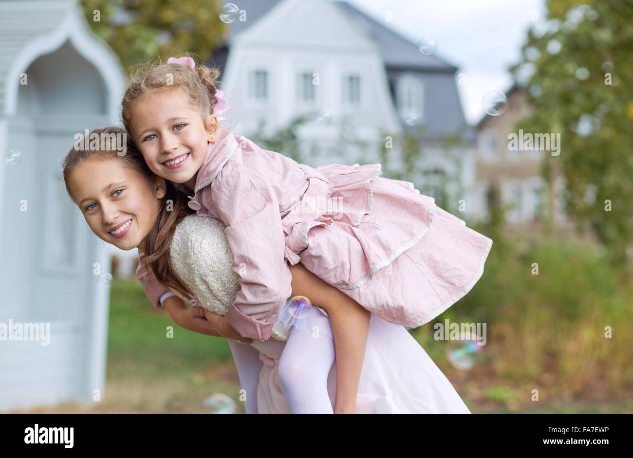 Two pretty sisters enjoying the autumn garden Stock Photo - Alamy