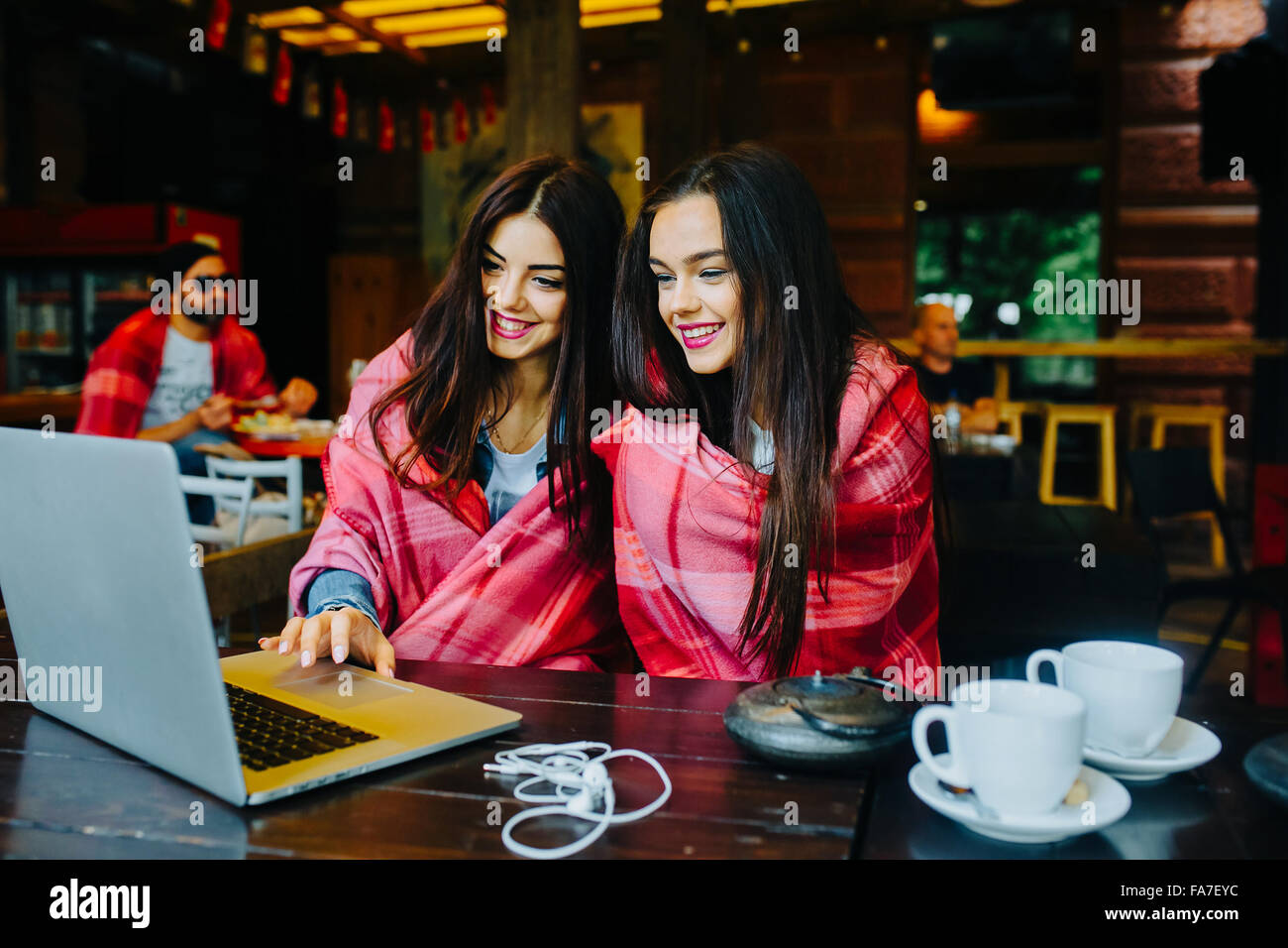 two girls watching something in laptop Stock Photo - Alamy