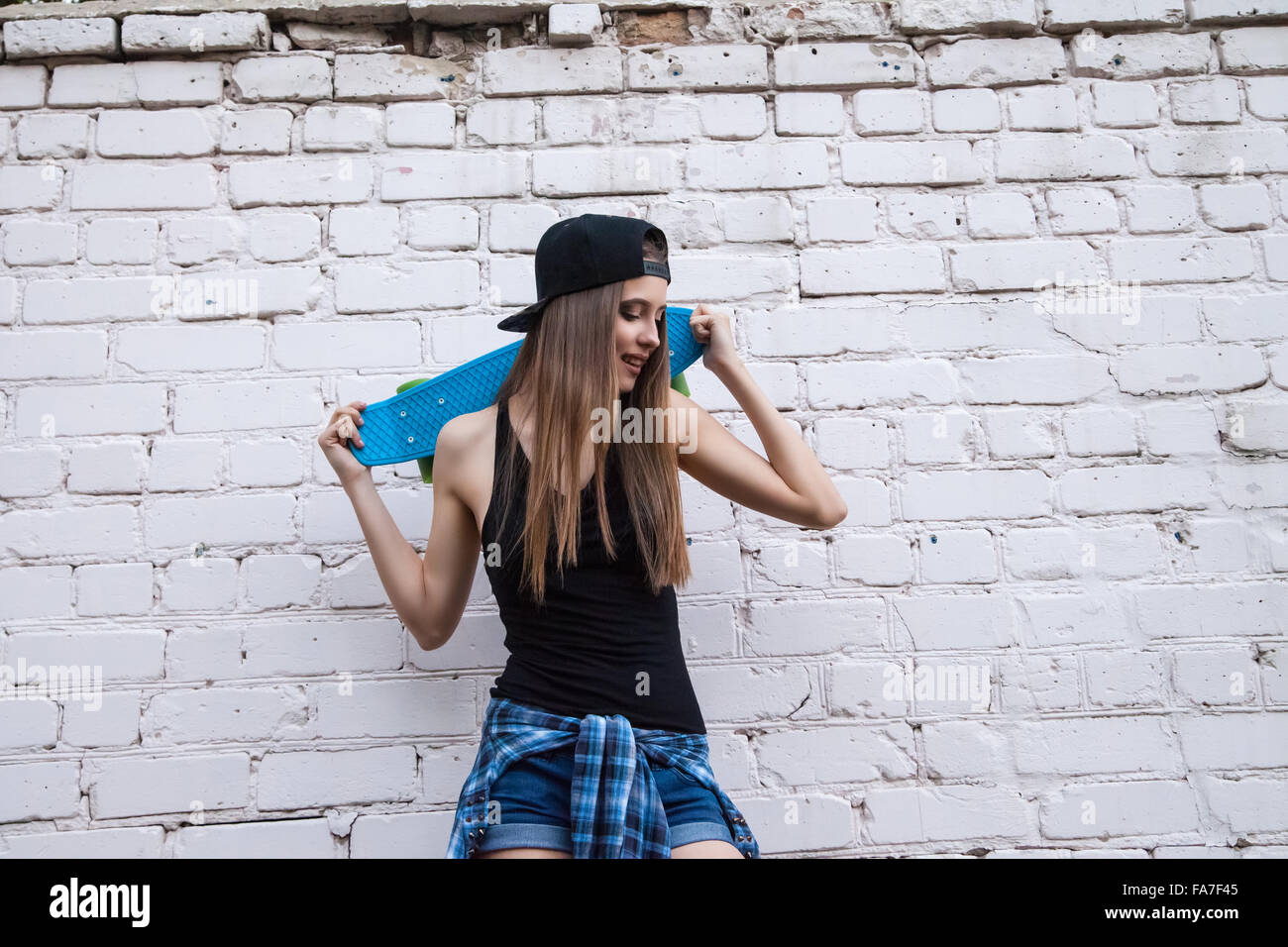 beautiful girl in shorts poses over brick wall Stock Photo - Alamy