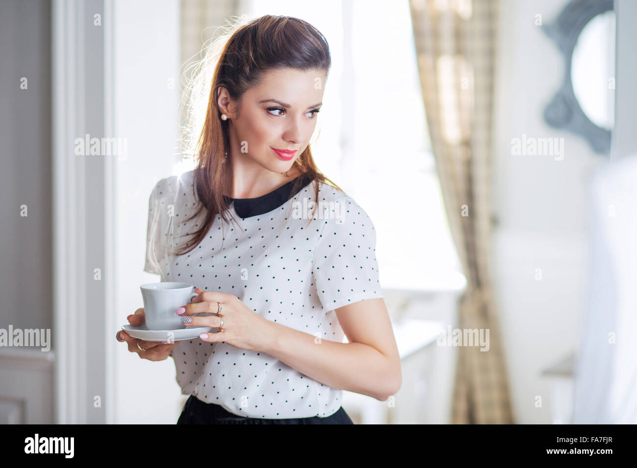 Pretty and smart lady drinking coffee Stock Photo - Alamy