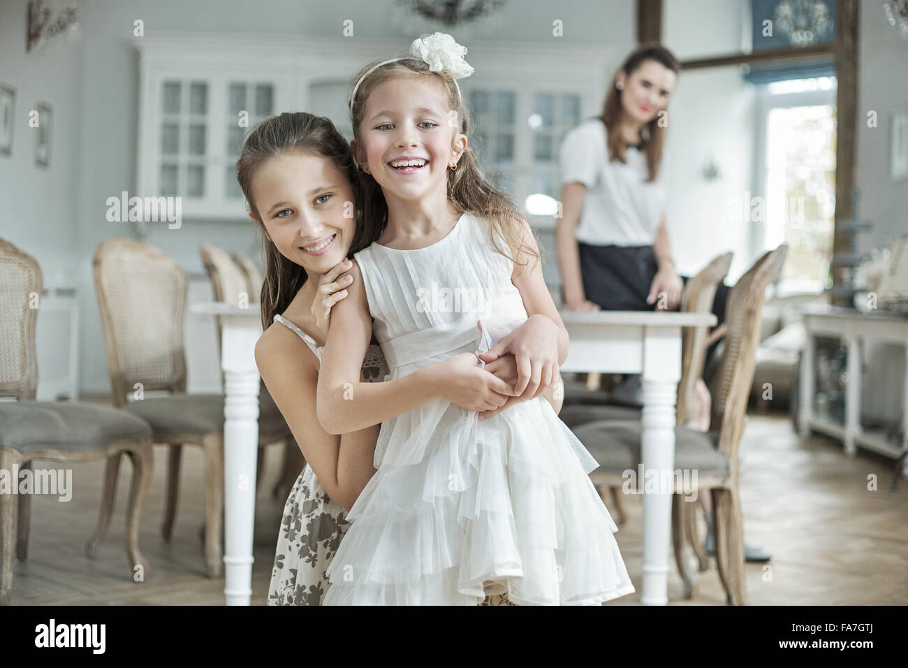 Two cheerful daughters posing with pretty mother Stock Photo - Alamy