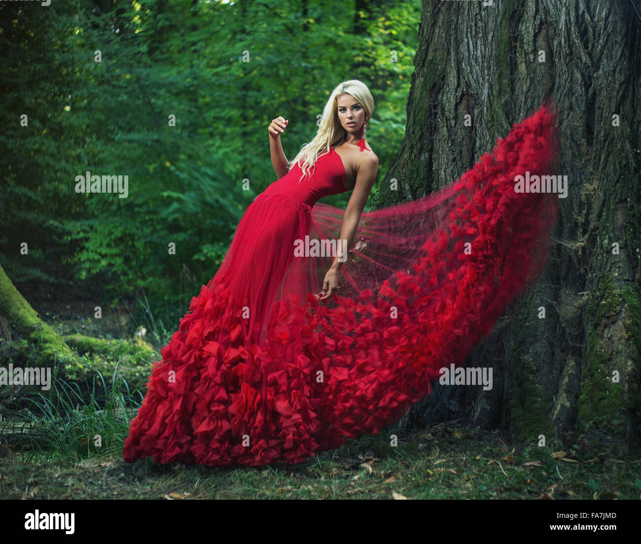 Beautiful woman wearing an amazing red dress Stock Photo - Alamy
