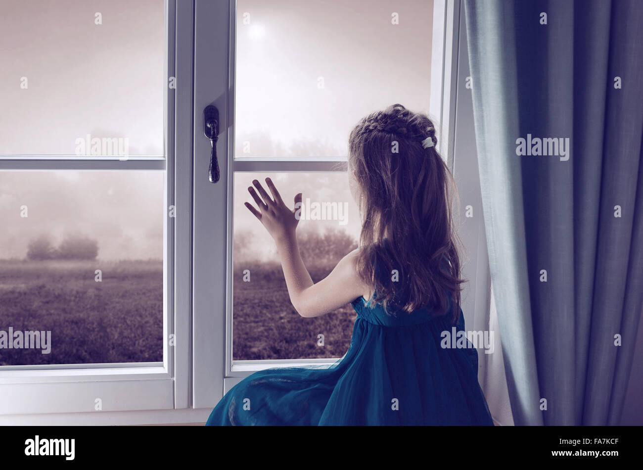 Miserable child looking through window Stock Photo - Alamy