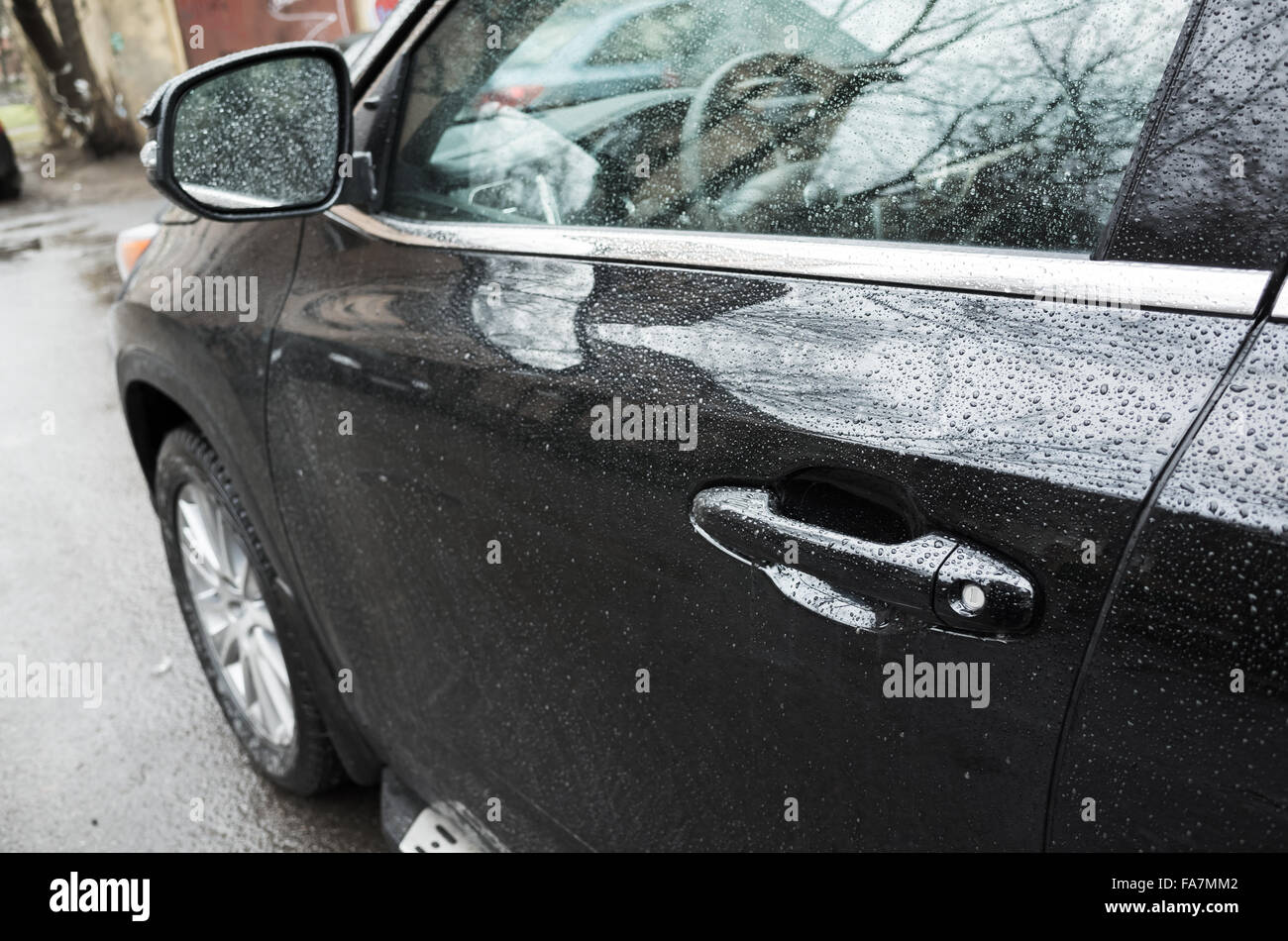 Closeup photo of black shining car, driver door. Selective focus and ...