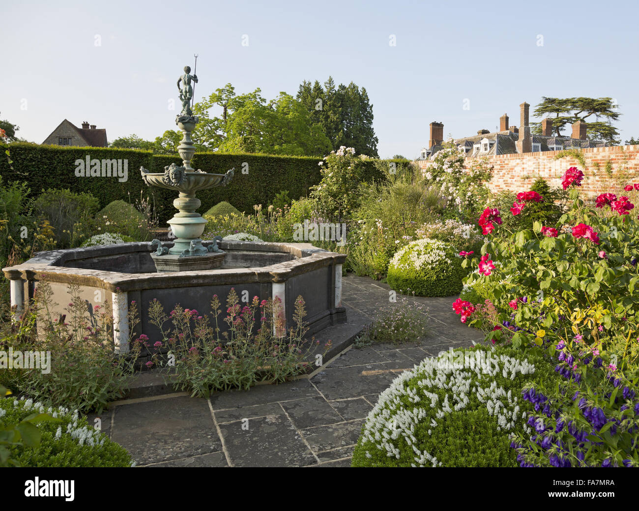 A view of the ornamental fountain, church and south front of Woolbeding ...