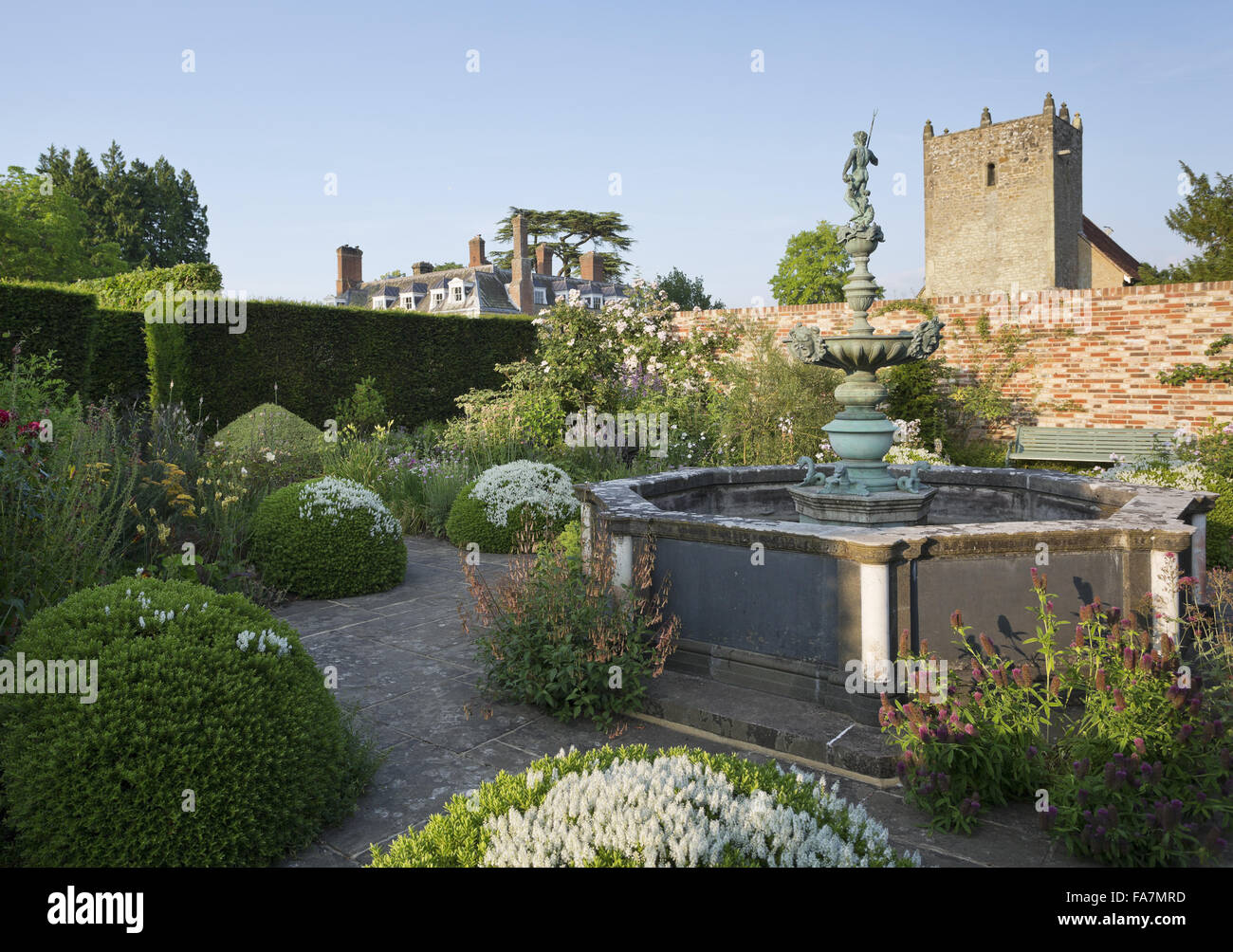 A view of the ornamental fountain, church and south front of Woolbeding ...