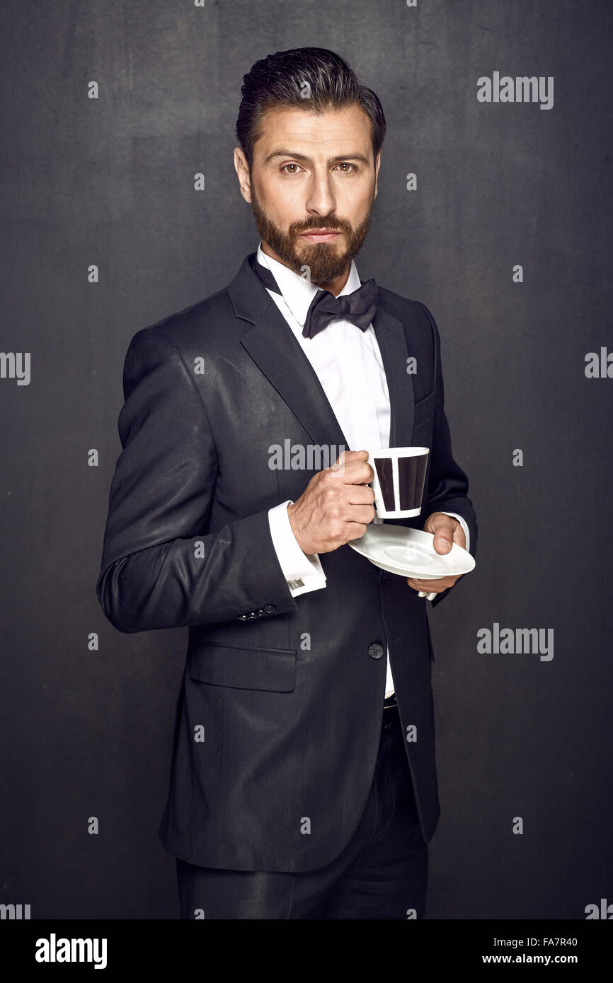 Elegant handsome guy drinking coffee Stock Photo - Alamy