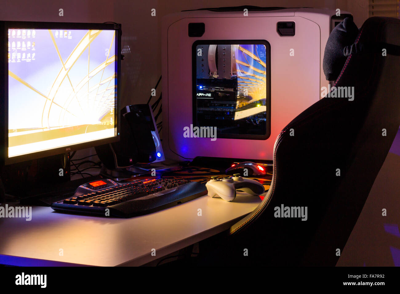 Custom built desktop computer for gaming on the table with joystick, monitor, keyboard, chair ...