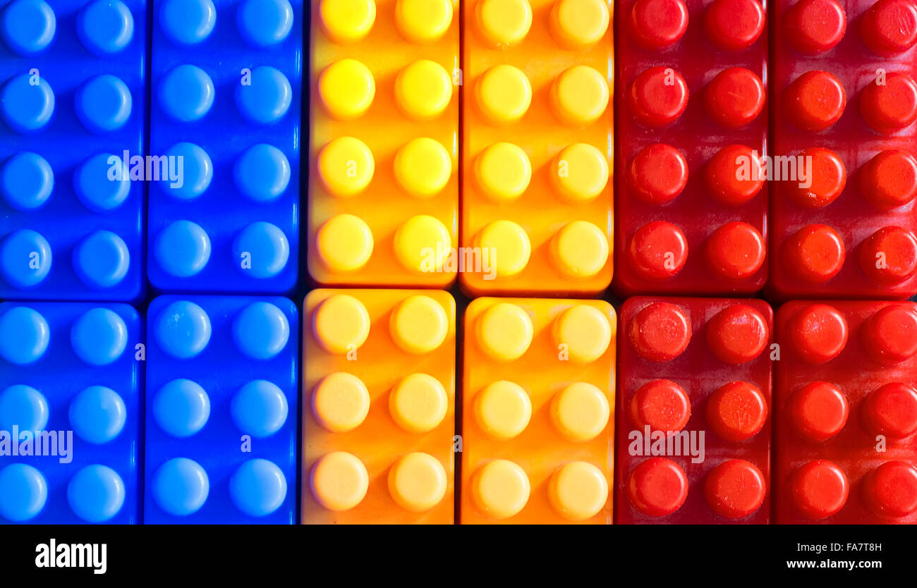 Surface covered with the colorful toy construction bricks as a ...