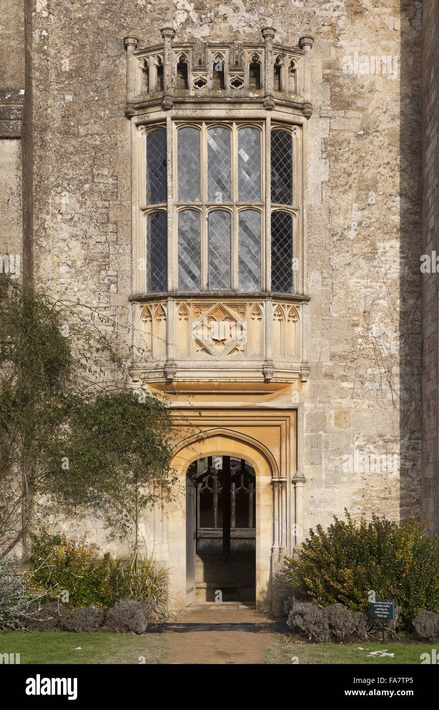 The oriel window with the doorway beneath on the south elevation of Lacock Abbey, Wiltshire. The ...
