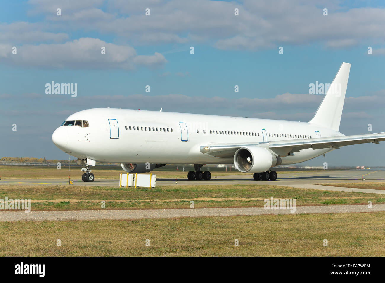 Big white passenger jet plane on runway at the airport on a sunny day ...